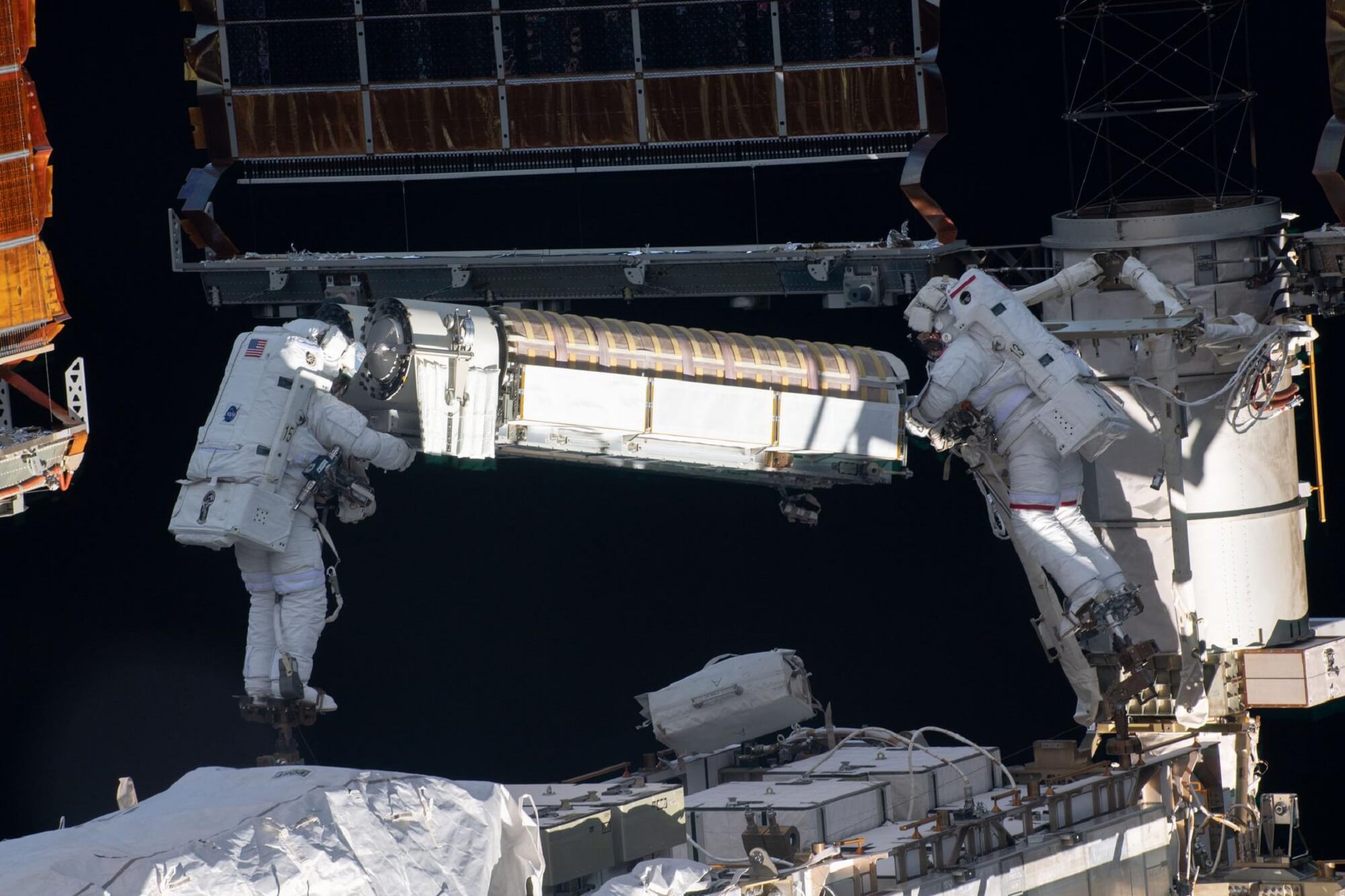 two_astronauts_installing_the_irosa_system_on_the_iss.jpg - AeroTime